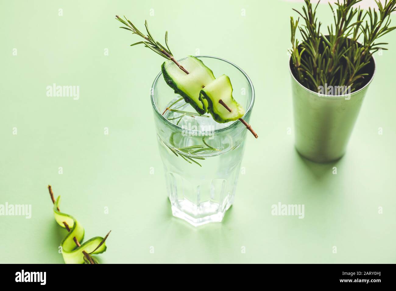 Glass of cold cucumber water on color background Stock Photo - Alamy