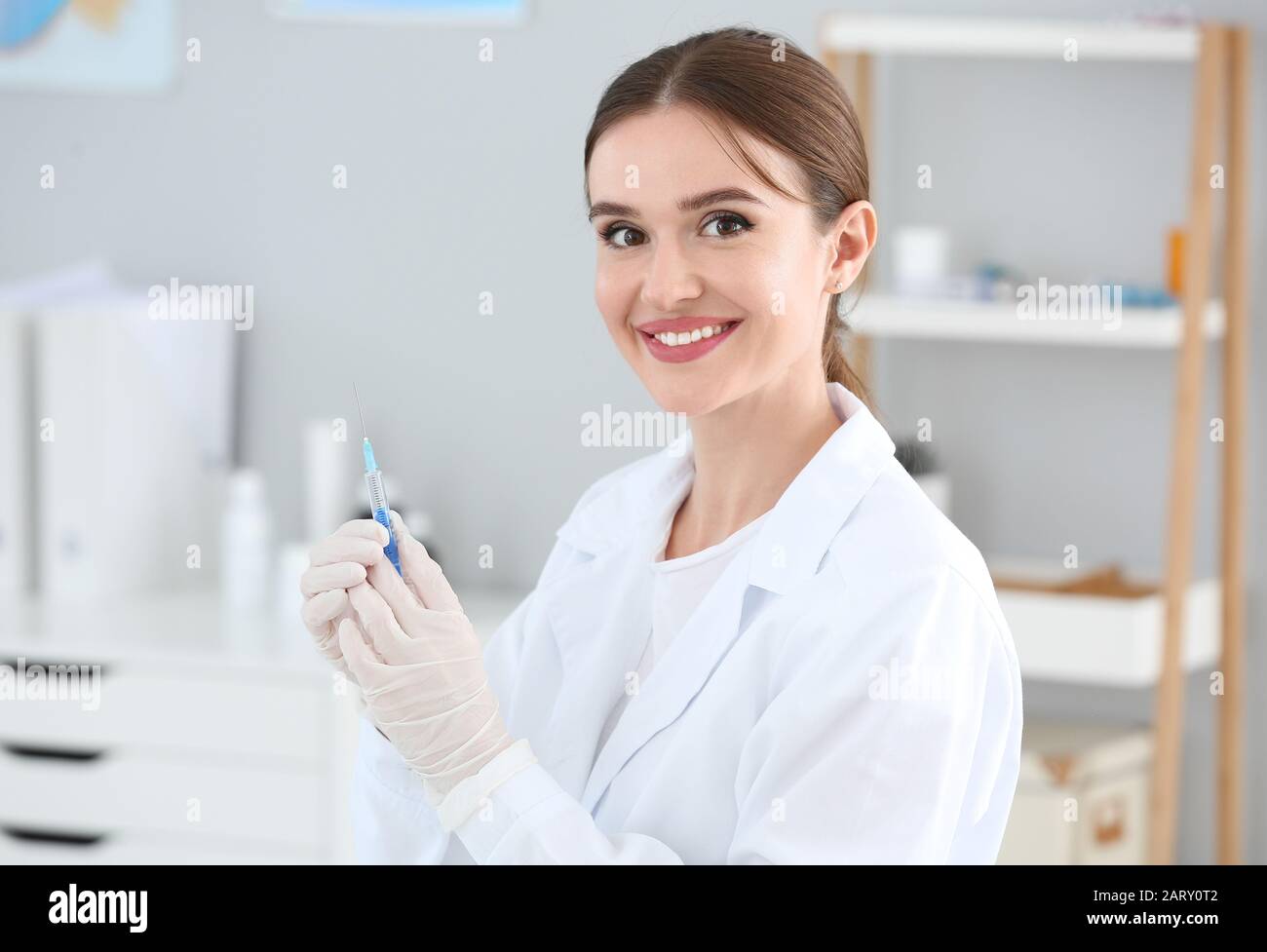 Doctor with syringe in clinic Stock Photo - Alamy