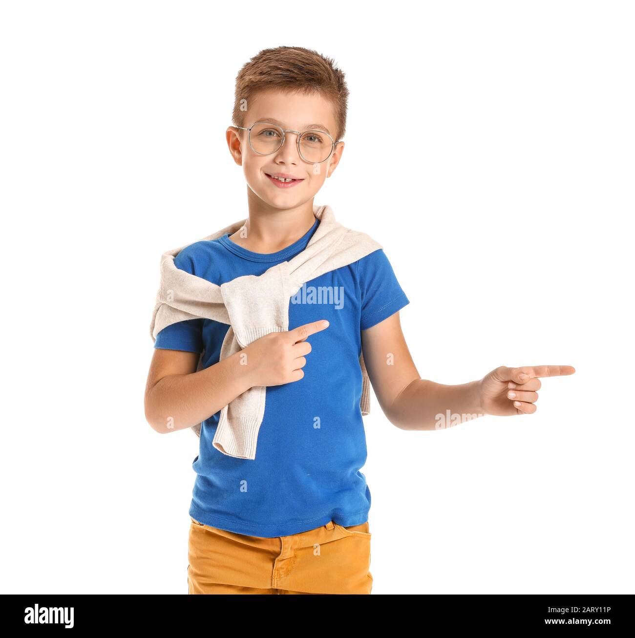 Cute fashionable boy pointing at something on white background Stock ...