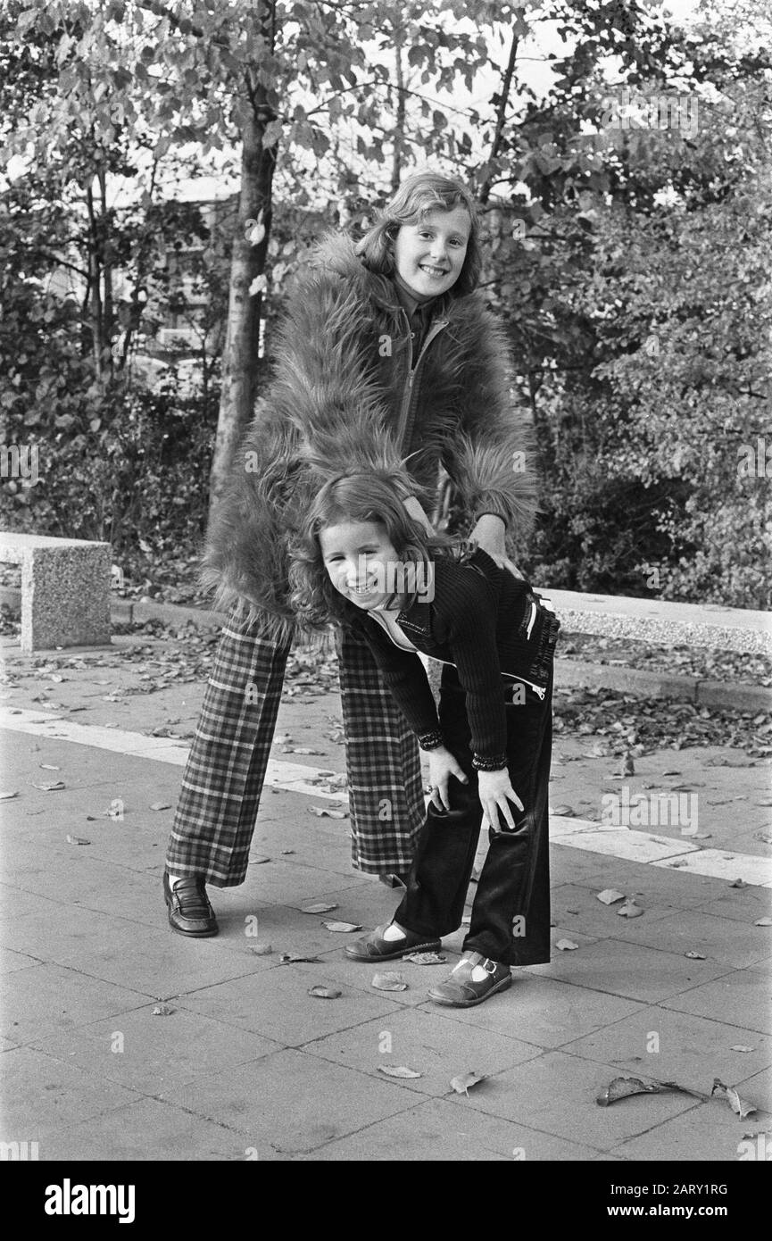 Children's fashion of the brand Mardy Two children present the clothing ...