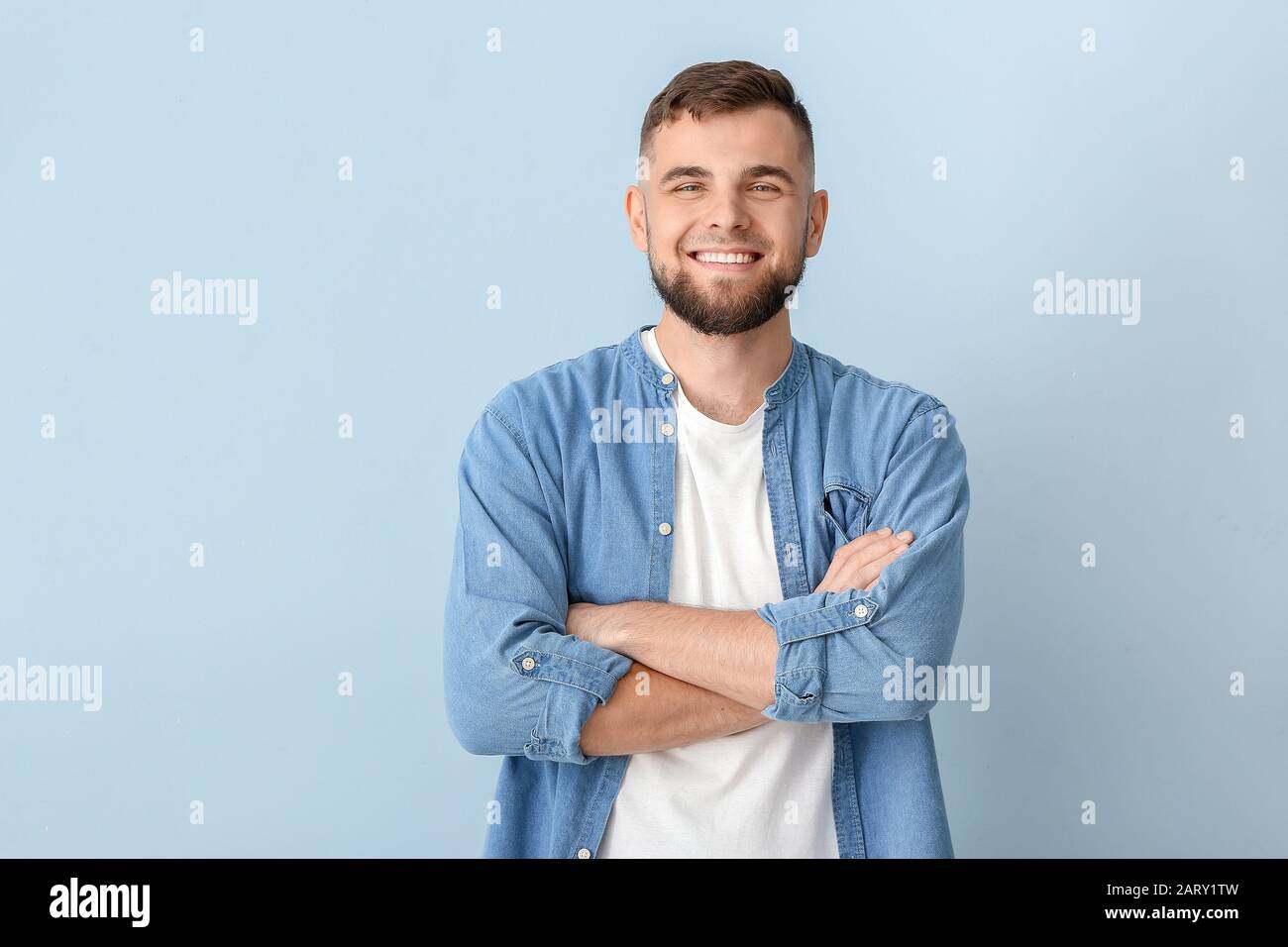 Handsome young man on color background Stock Photo - Alamy