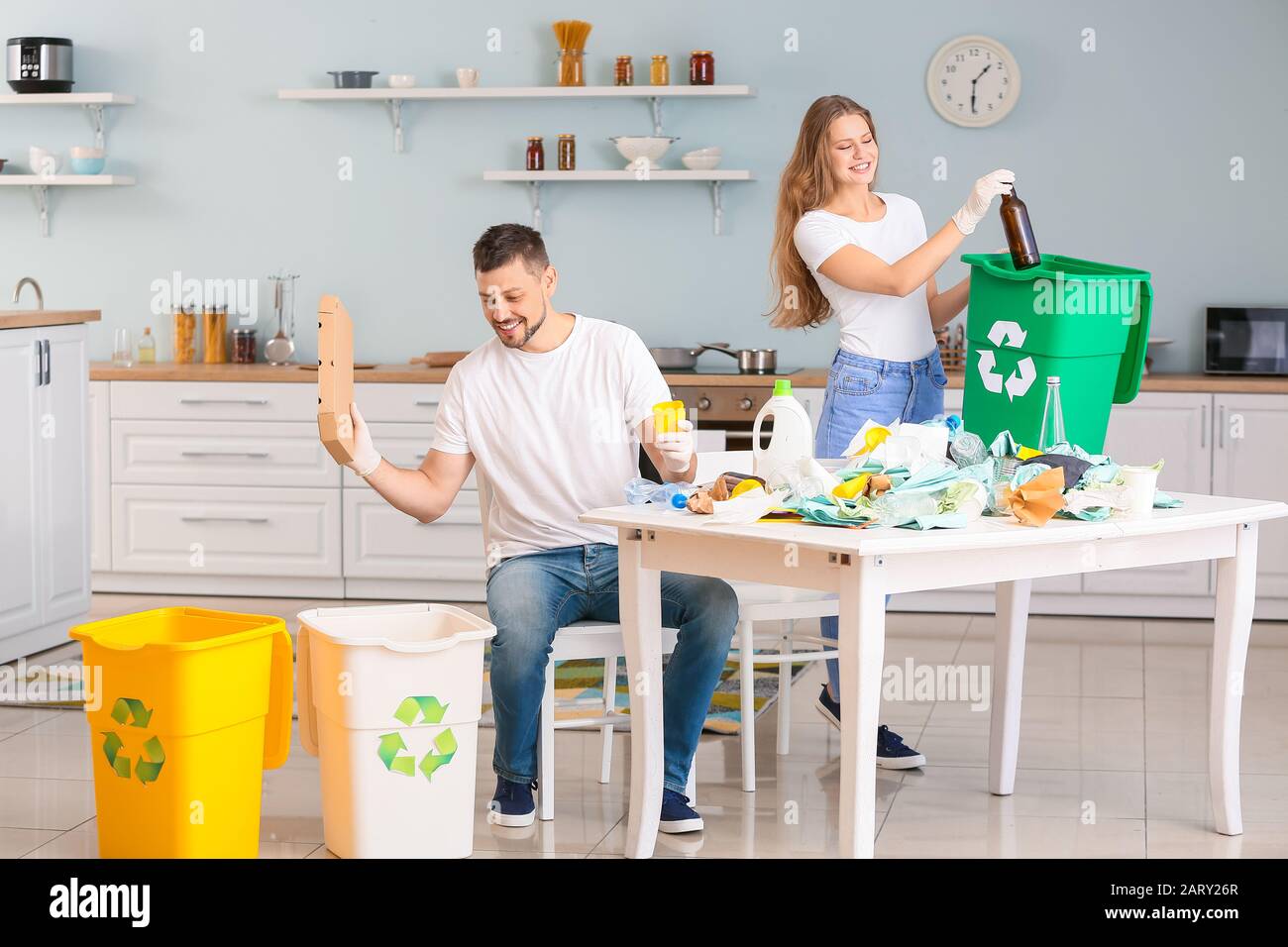 Couple sorting garbage at home. Concept of recycling Stock Photo - Alamy