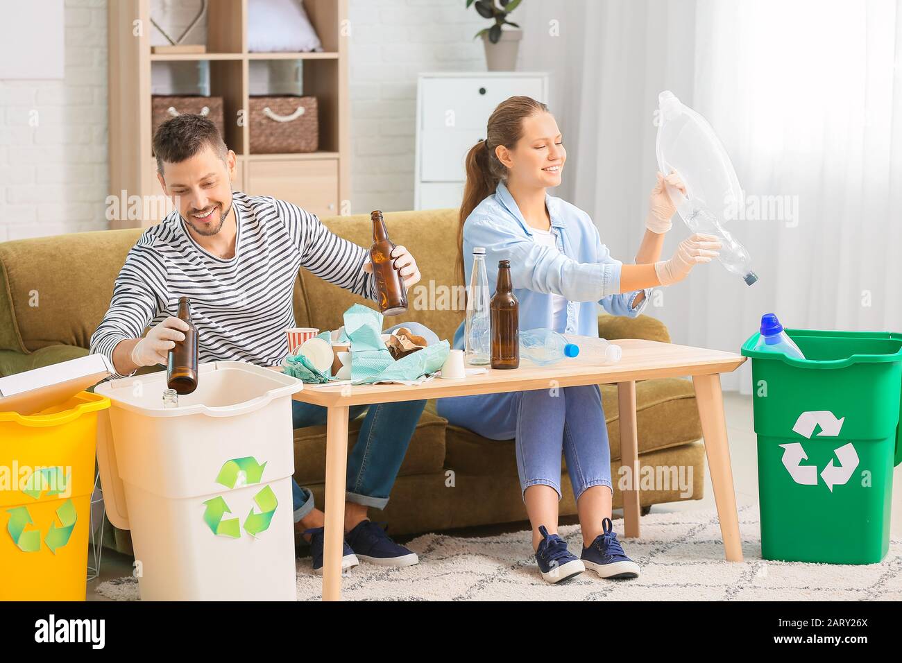 Couple sorting garbage at home. Concept of recycling Stock Photo - Alamy