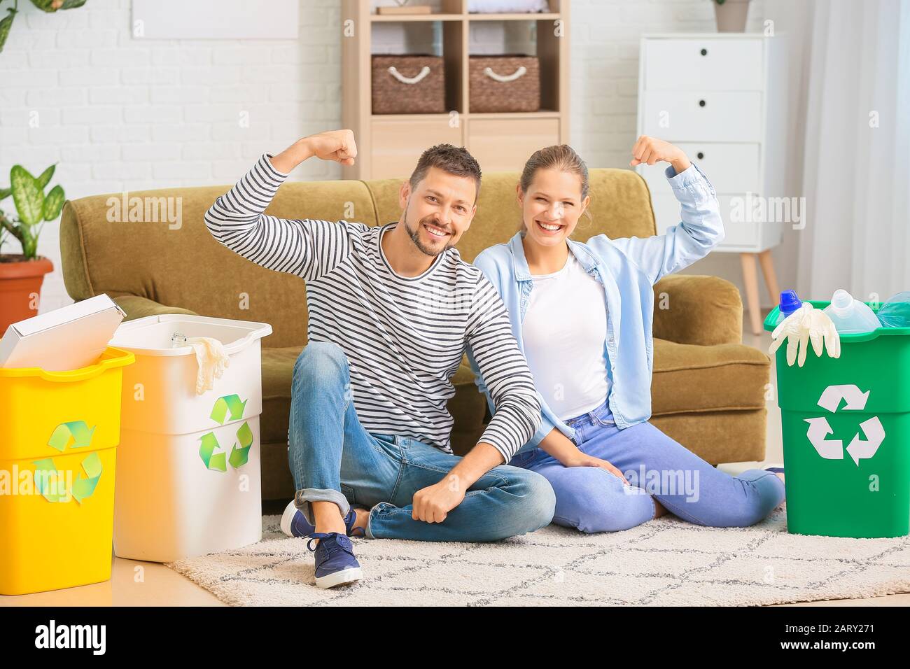 Couple sorting garbage at home. Concept of recycling Stock Photo - Alamy