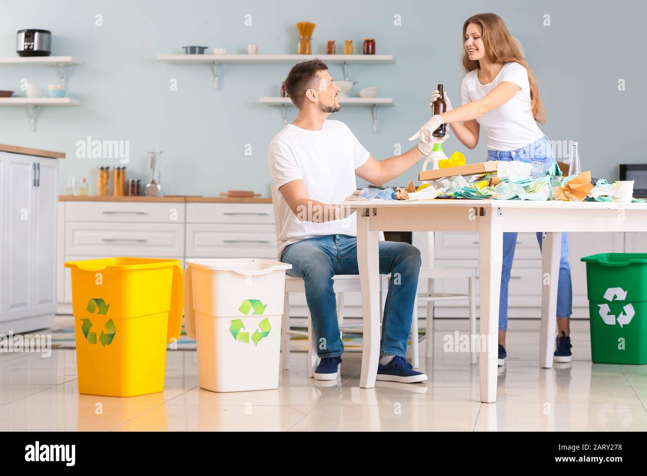 Couple sorting garbage at home. Concept of recycling Stock Photo - Alamy
