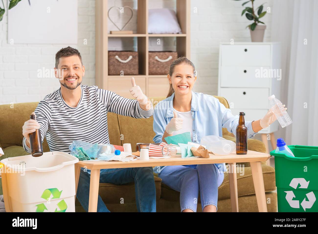 Couple sorting garbage at home. Concept of recycling Stock Photo - Alamy