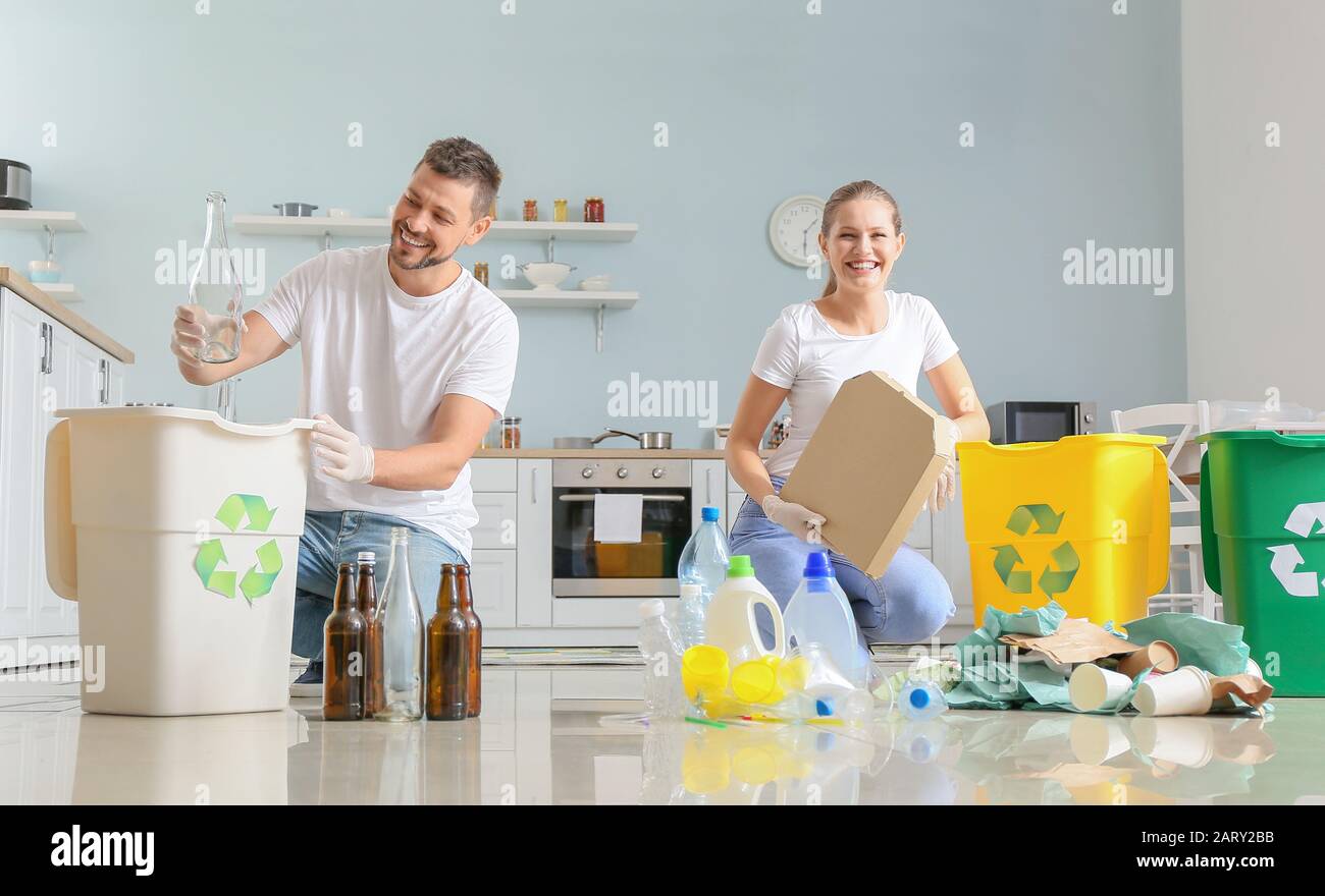 Couple sorting garbage at home. Concept of recycling Stock Photo - Alamy