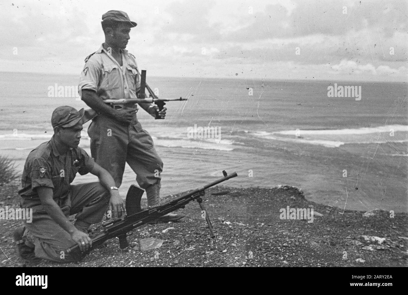 Reportage Hollandia Two soldiers posing with weapons at the sea ...
