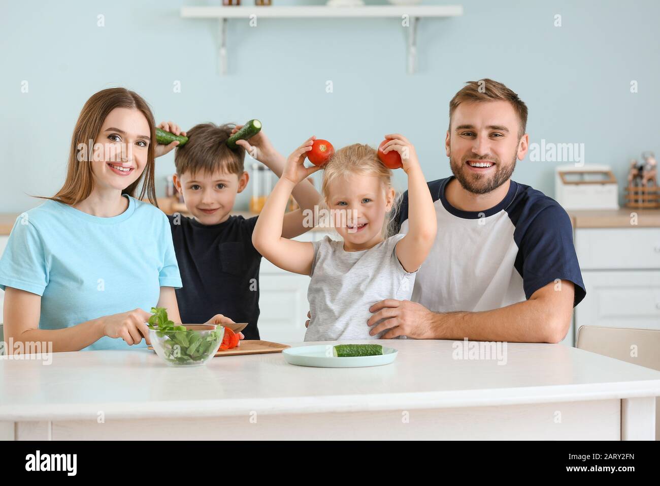 Happy family cooking together in kitchen Stock Photo - Alamy