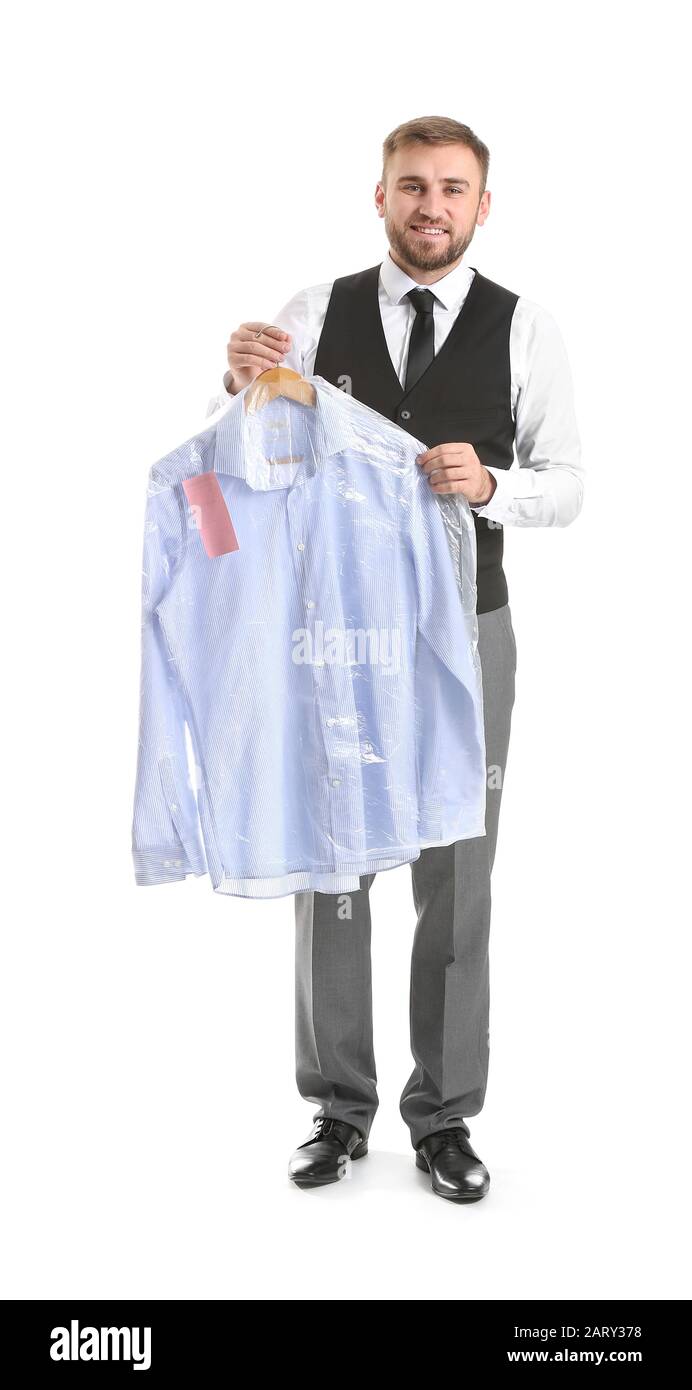 Male worker of modern dry-cleaner's with clothes on white background ...
