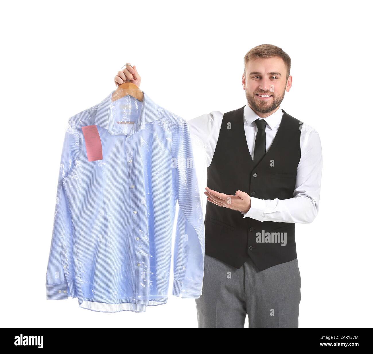 Male worker of modern dry-cleaner's with clothes on white background ...