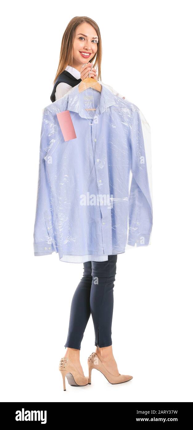 Female worker of modern dry-cleaner's with clothes on white background ...