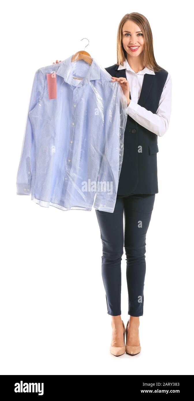 Female worker of modern dry-cleaner's with clothes on white background ...