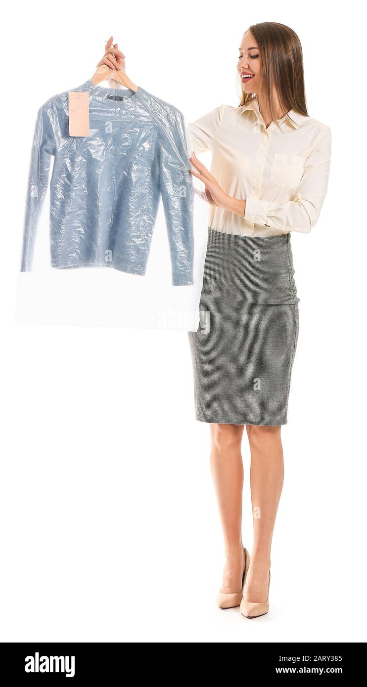 Female worker of modern dry-cleaner's with clothes on white background ...