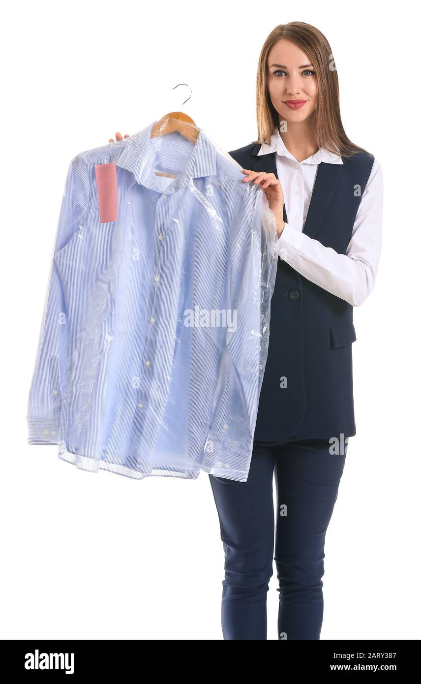 Female worker of modern dry-cleaner's with clothes on white background ...