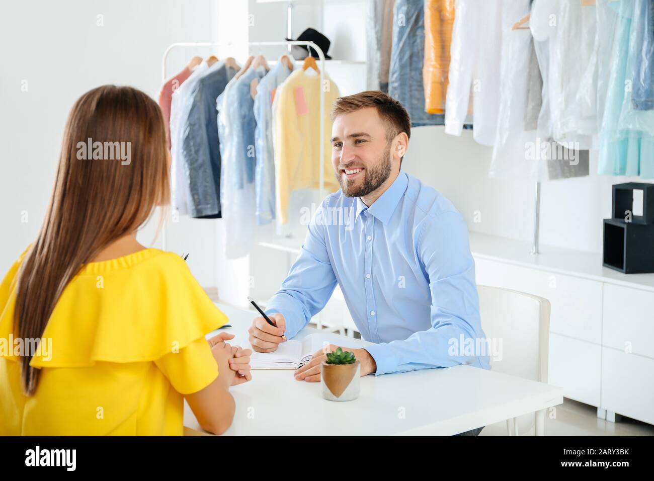 Client making order at modern dry-cleaner's Stock Photo - Alamy