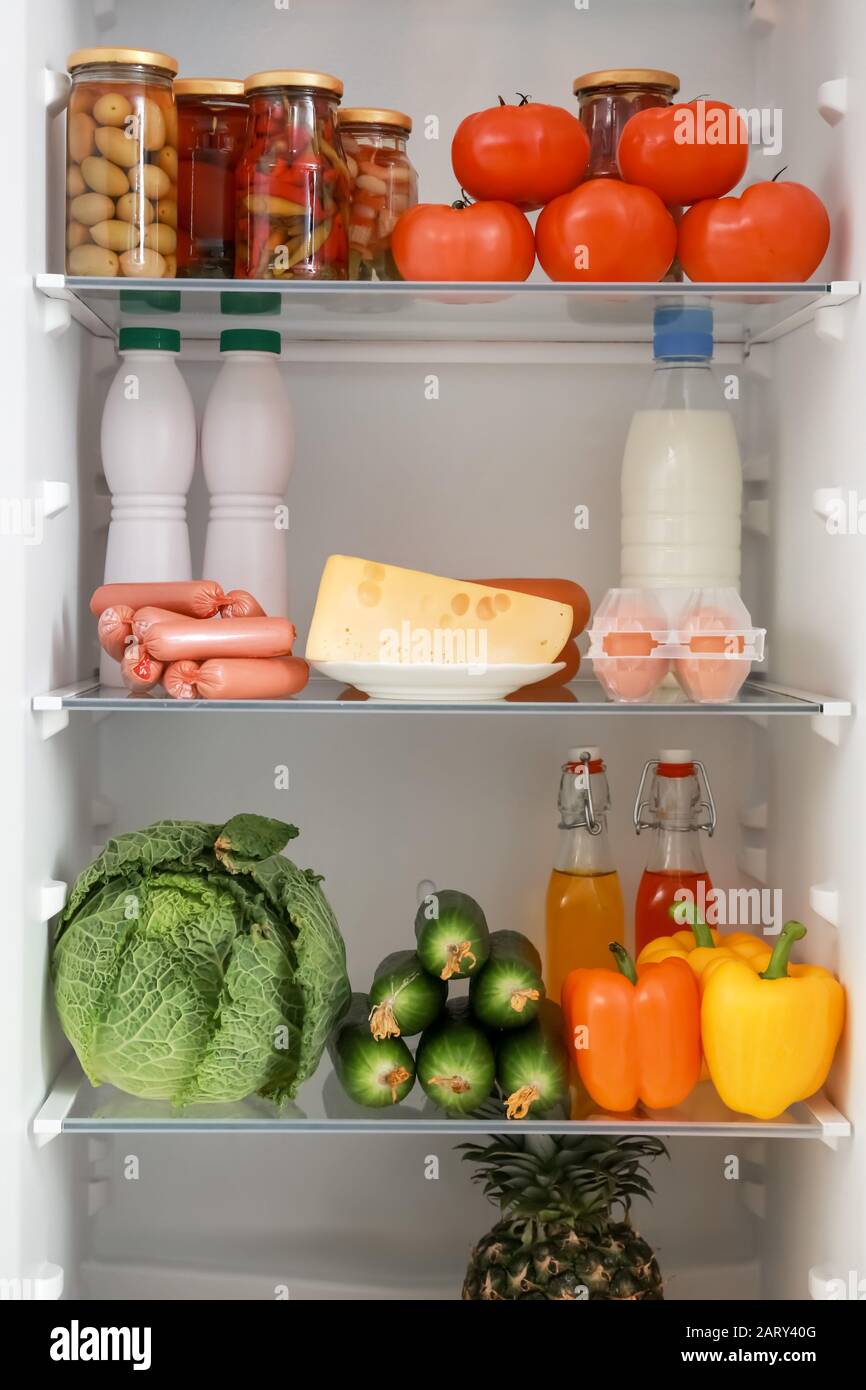Different products on shelves in fridge Stock Photo - Alamy