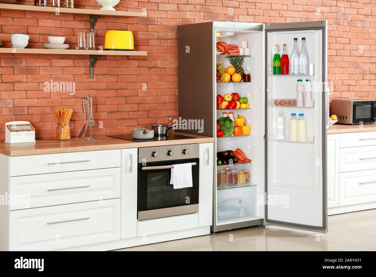 Open big fridge with products in interior of kitchen Stock Photo - Alamy