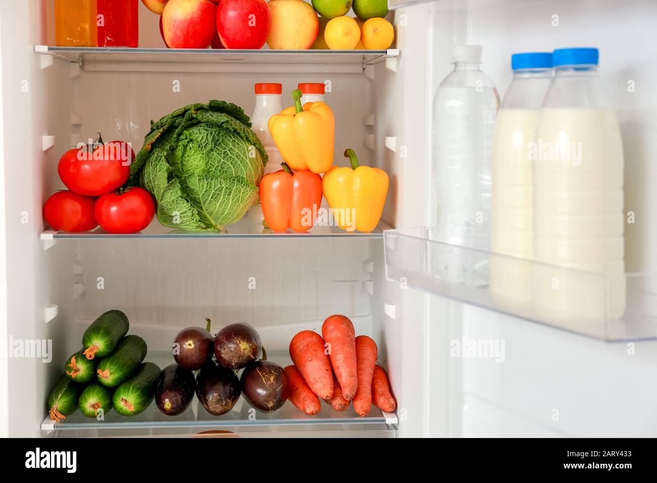 Different products on shelves in fridge Stock Photo - Alamy