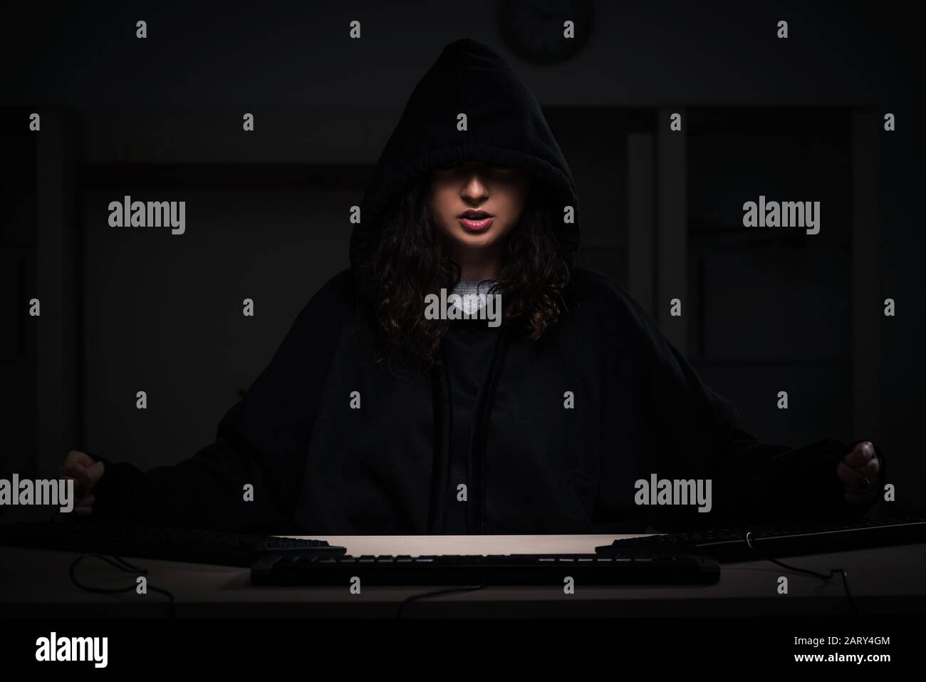 The female hacker hacking security firewall late in office Stock Photo ...