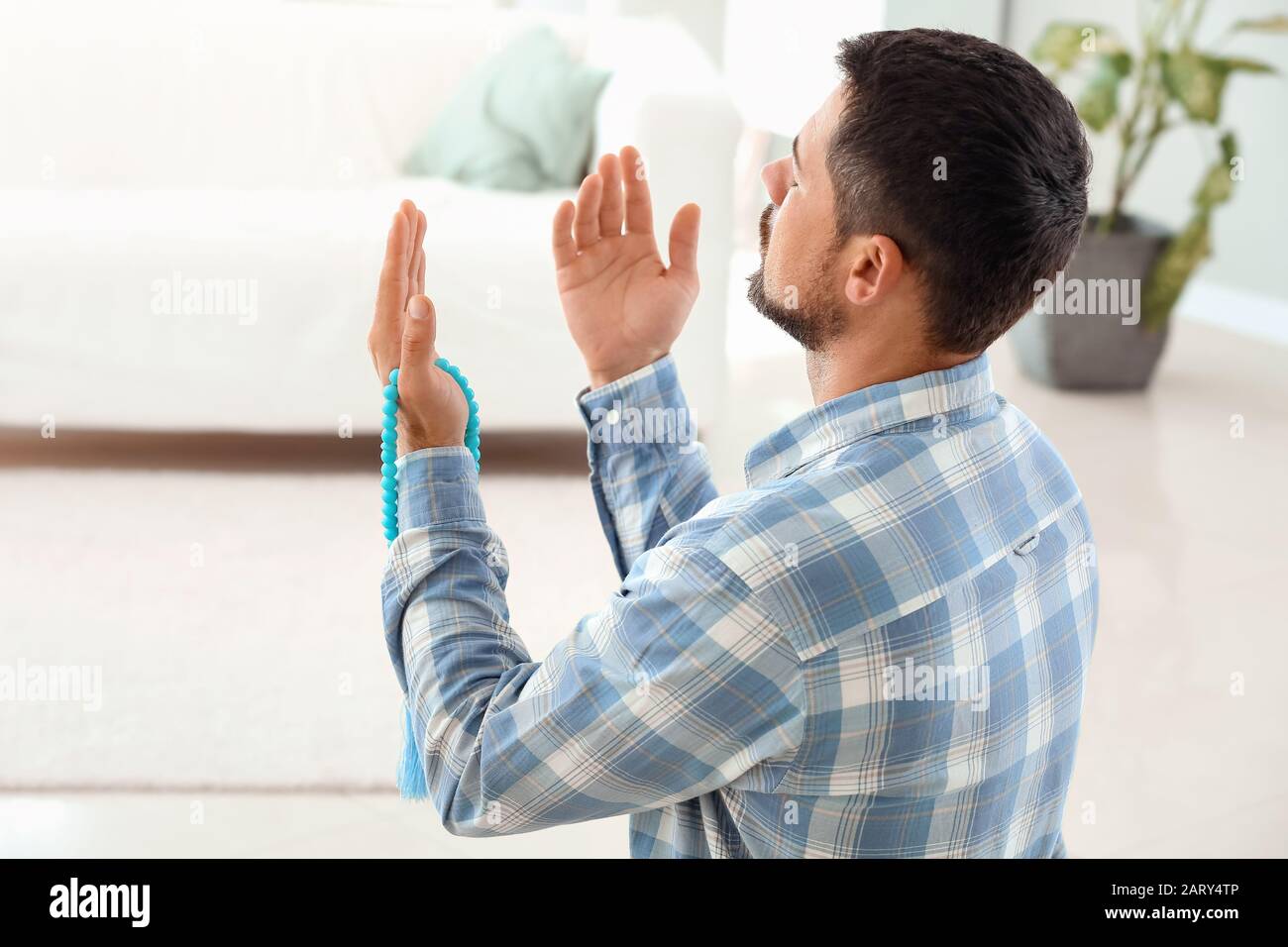 Muslim man praying at home Stock Photo - Alamy