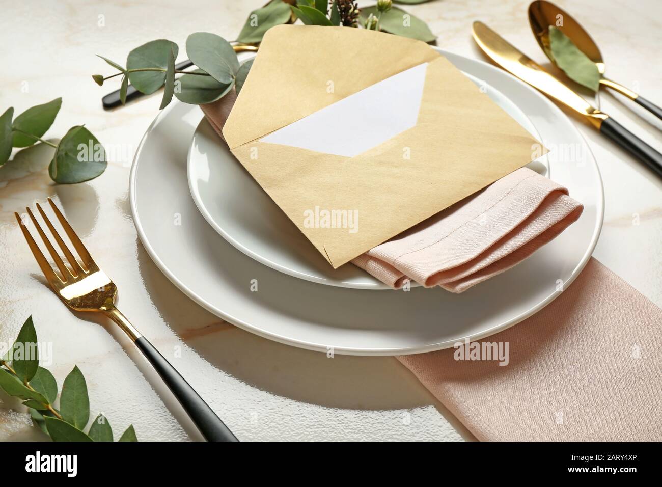 Table setting with invitation on white background Stock Photo - Alamy