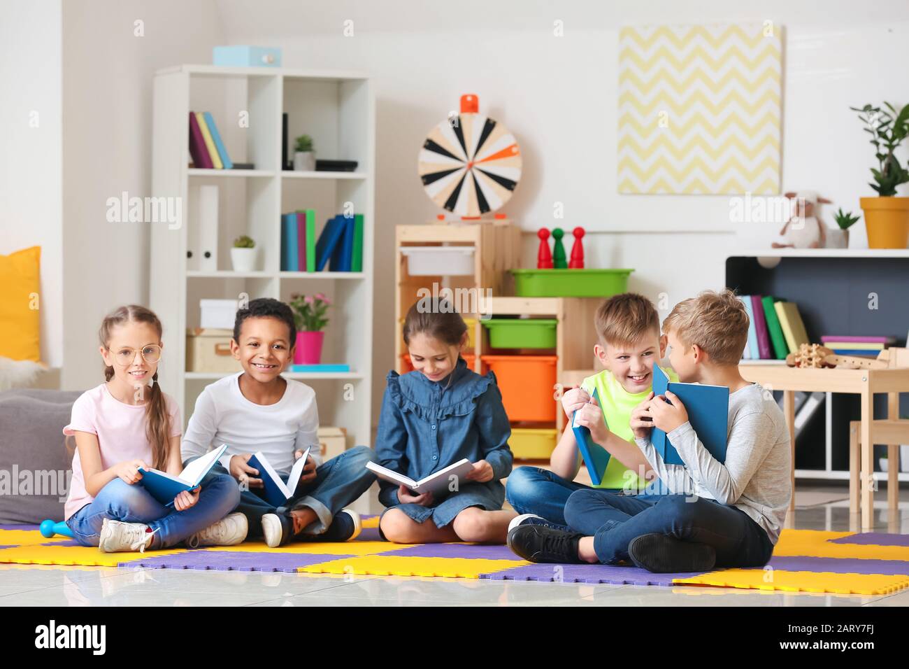 Cute little children reading books indoors Stock Photo - Alamy