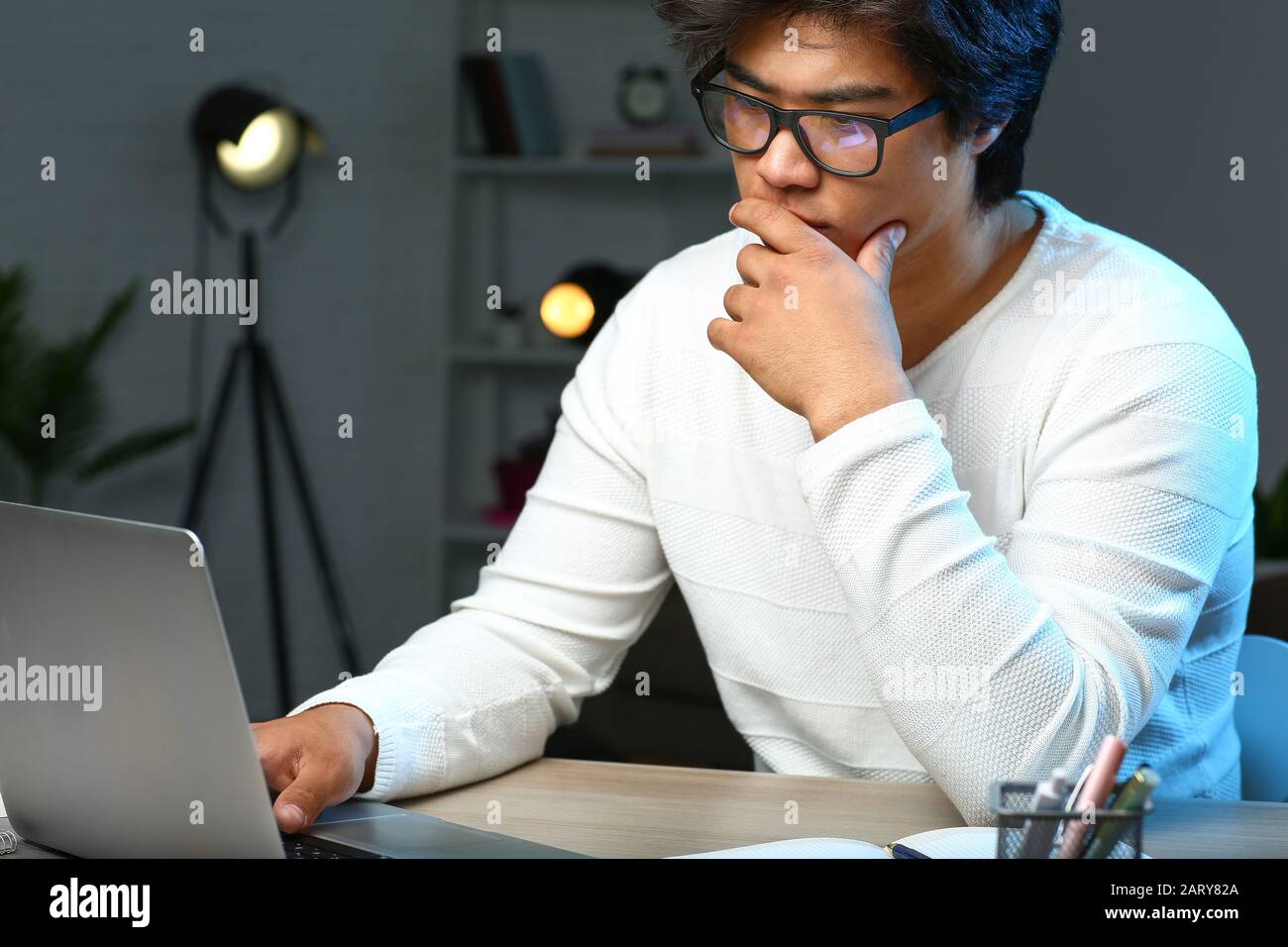 Asian programmer working late in evening Stock Photo - Alamy