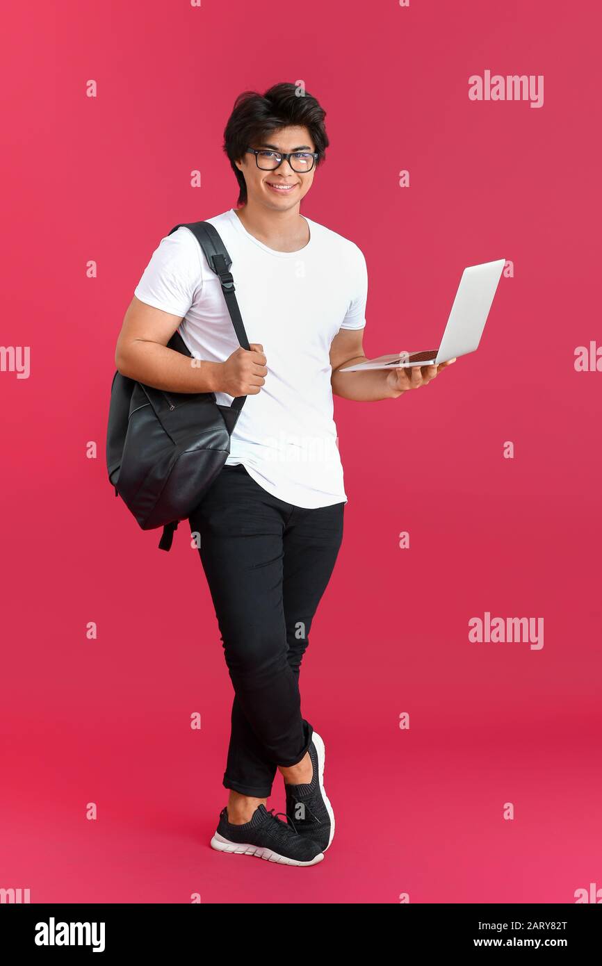 Male Asian programmer with laptop on color background Stock Photo - Alamy
