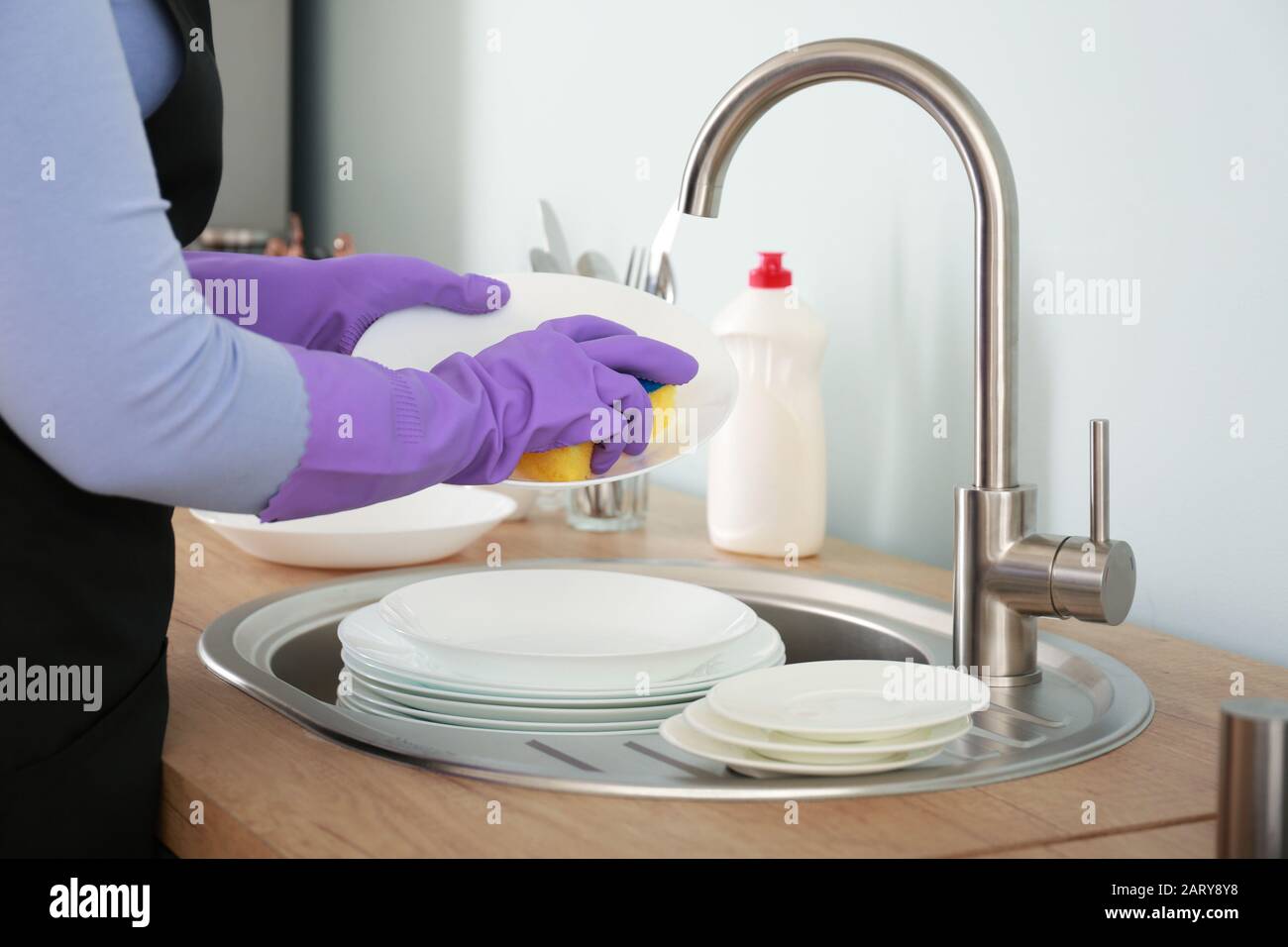 Woman washing dishes in kitchen Stock Photo - Alamy