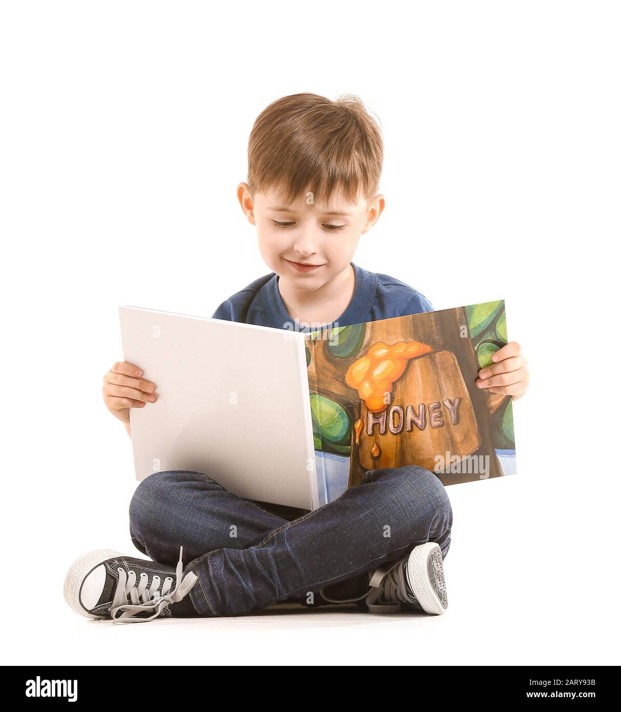 Cute little boy reading book on white background Stock Photo - Alamy
