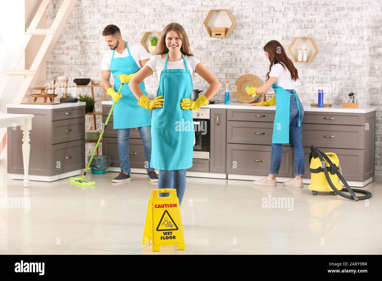 Female janitor with colleagues in kitchen Stock Photo - Alamy
