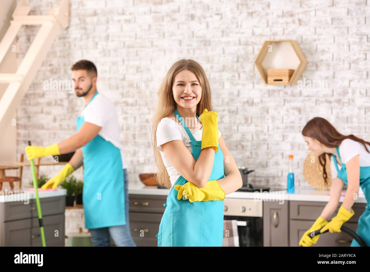 Female janitor with colleagues in kitchen Stock Photo - Alamy