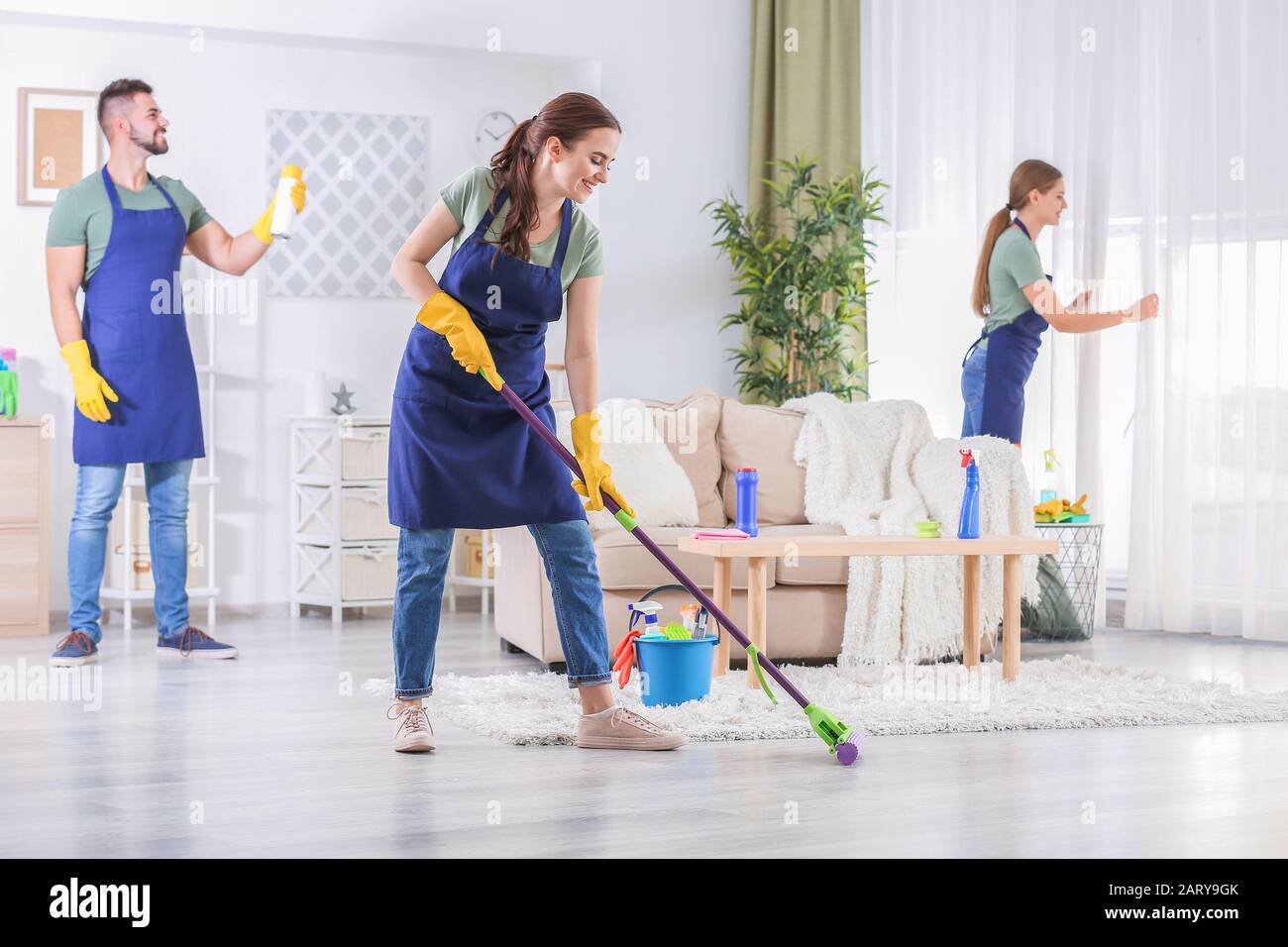 Team of janitors cleaning room Stock Photo - Alamy