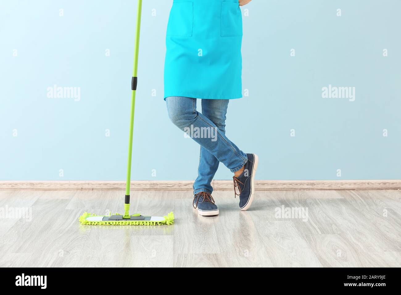 Male janitor with floor mop indoors Stock Photo - Alamy