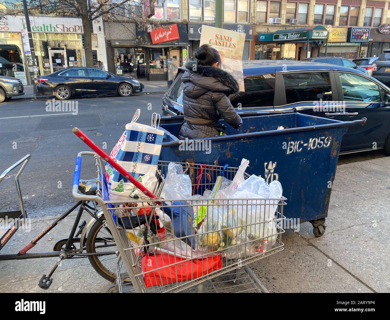 Woman dumpster diving hi-res stock photography and images - Alamy