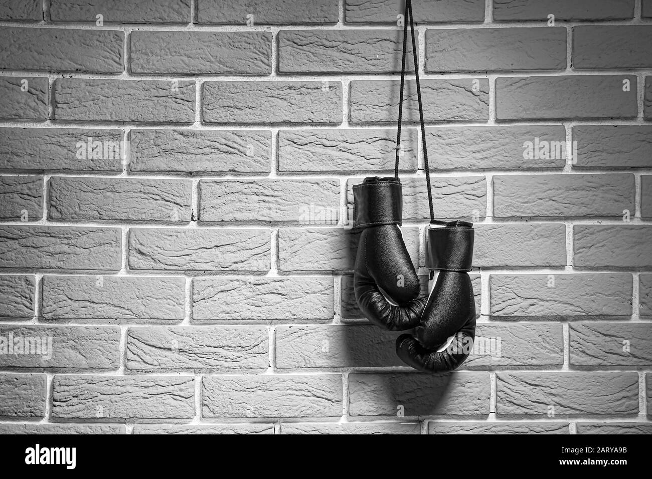 Boxing gloves on wall Black and White Stock Photos & Images - Alamy
