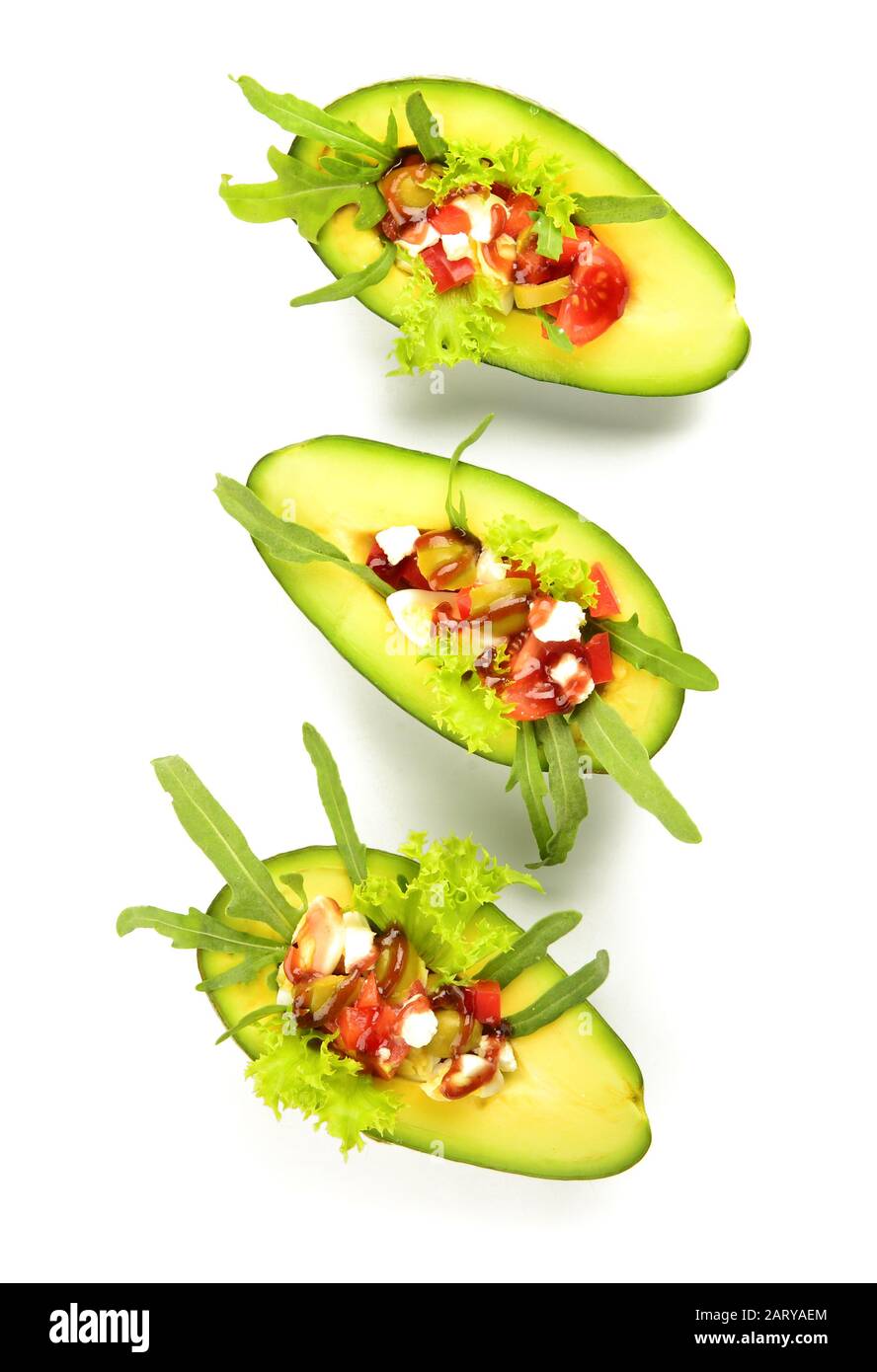 Tasty avocado with filling on white background Stock Photo - Alamy
