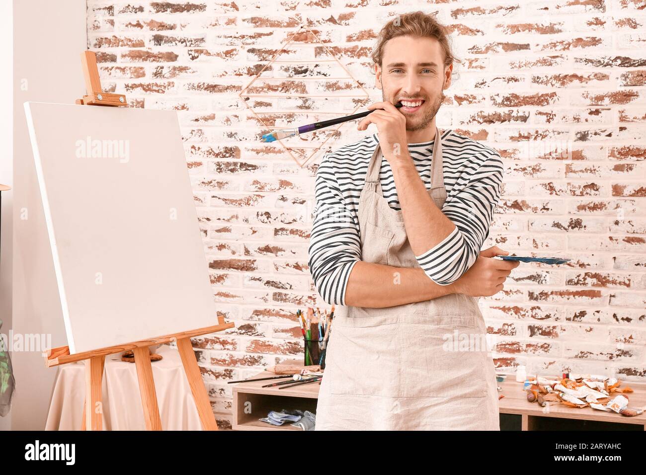 Young male artist painting at home Stock Photo - Alamy