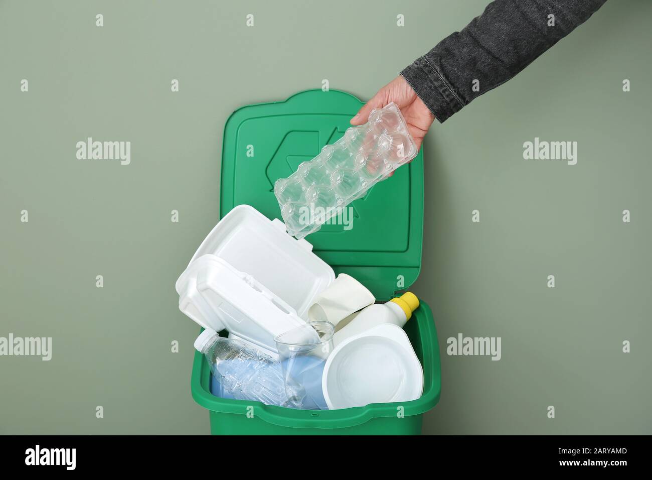 Man throwing garbage into container. Recycling concept Stock Photo - Alamy