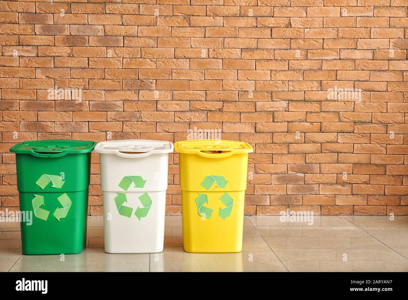 Containers for garbage near brick wall. Recycling concept Stock Photo ...