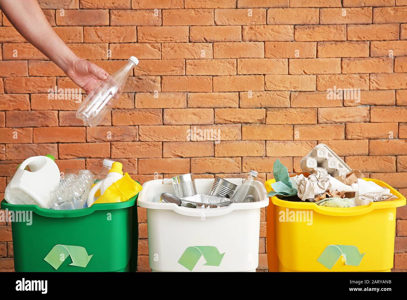 Man throwing garbage into container. Recycling concept Stock Photo - Alamy