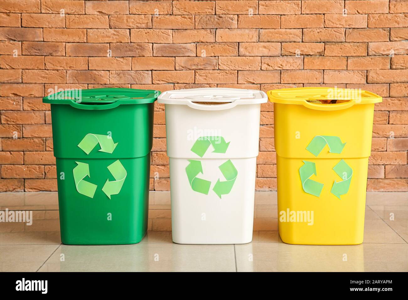 Containers for garbage near brick wall. Recycling concept Stock Photo ...