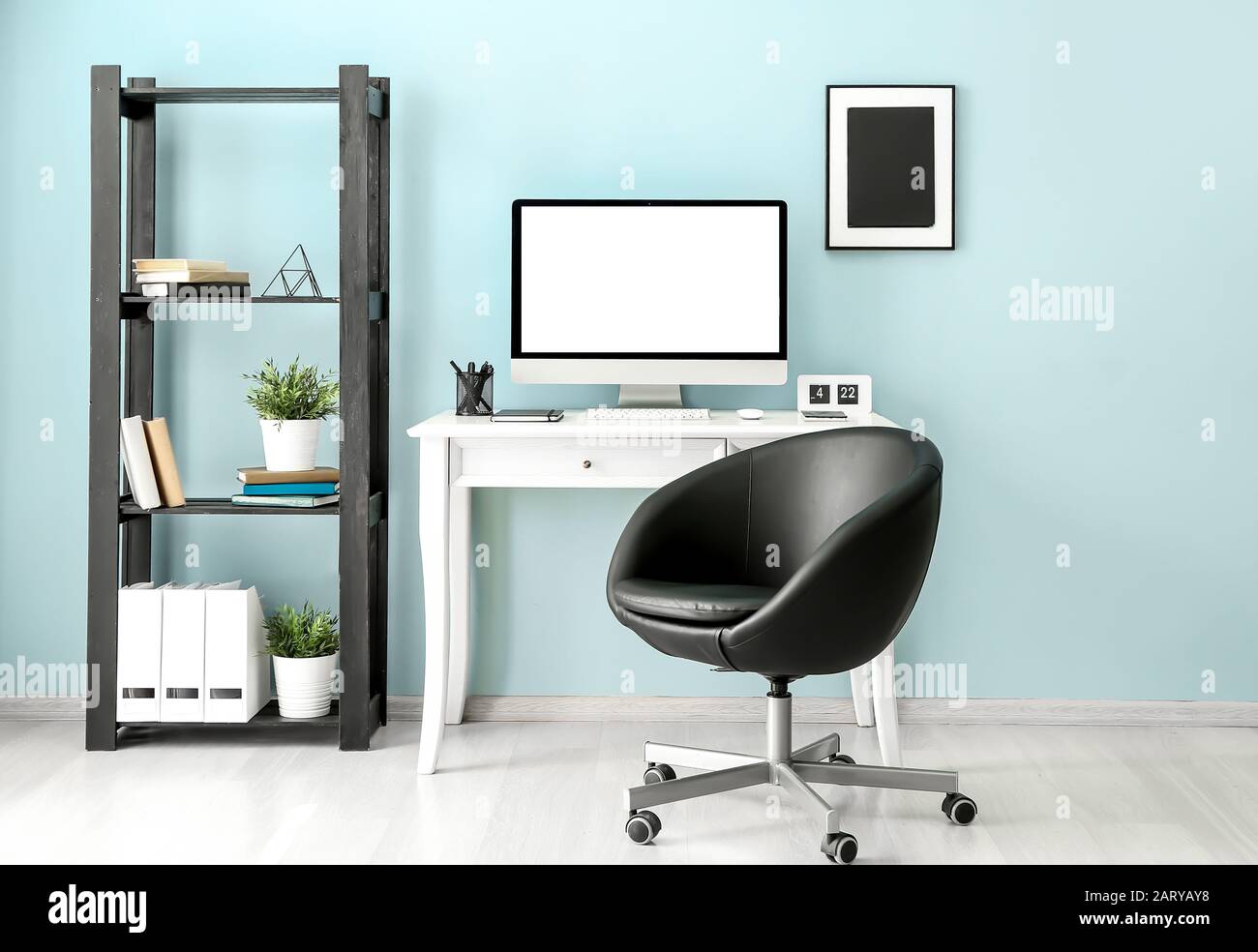 Comfortable workplace with modern computer near color wall Stock Photo ...