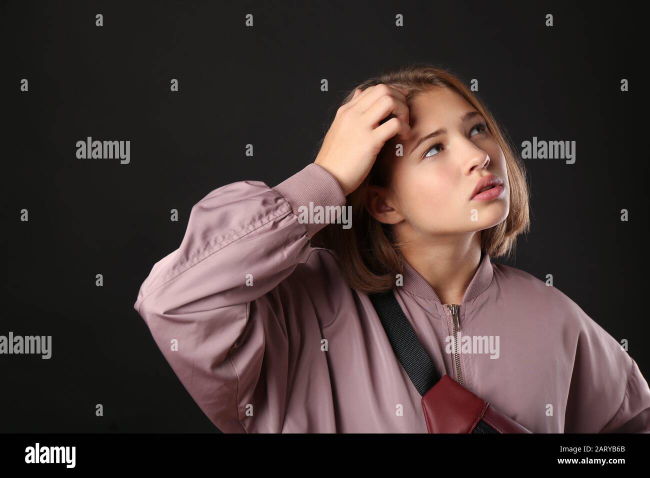 Thoughtful teenage girl on dark background Stock Photo - Alamy