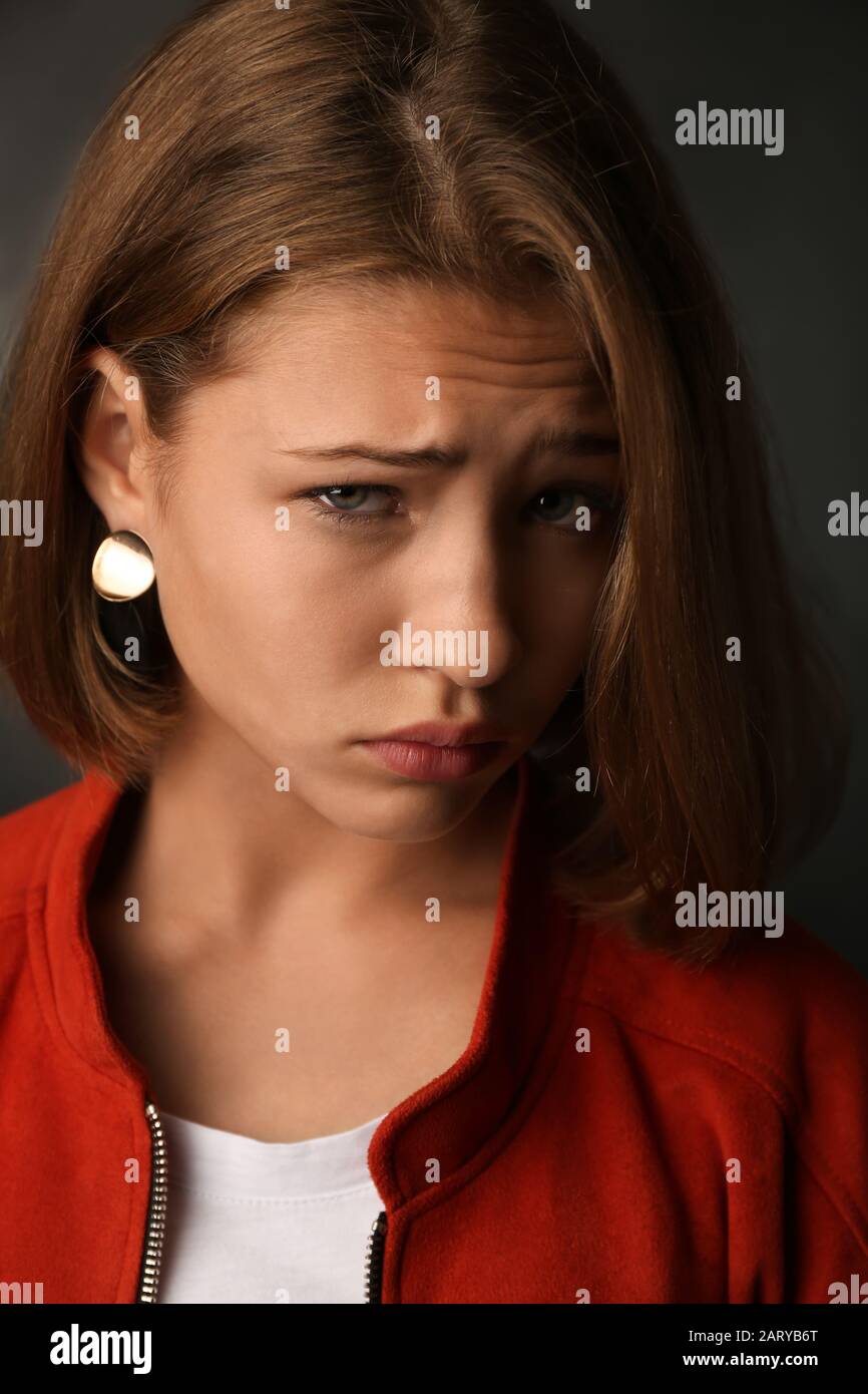 Sad teenage girl on dark background Stock Photo - Alamy