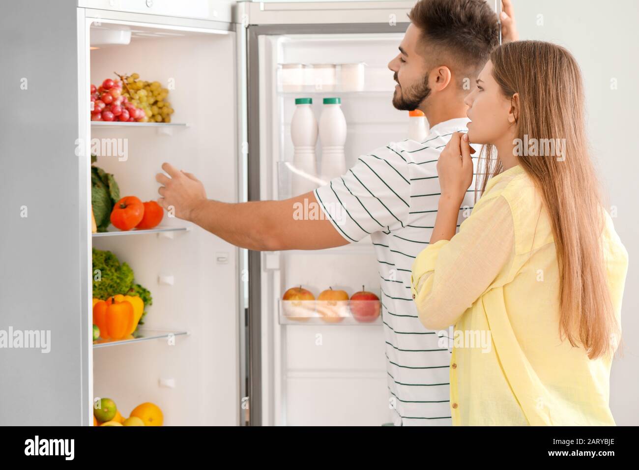 Man eating out of fridge hi-res stock photography and images - Alamy