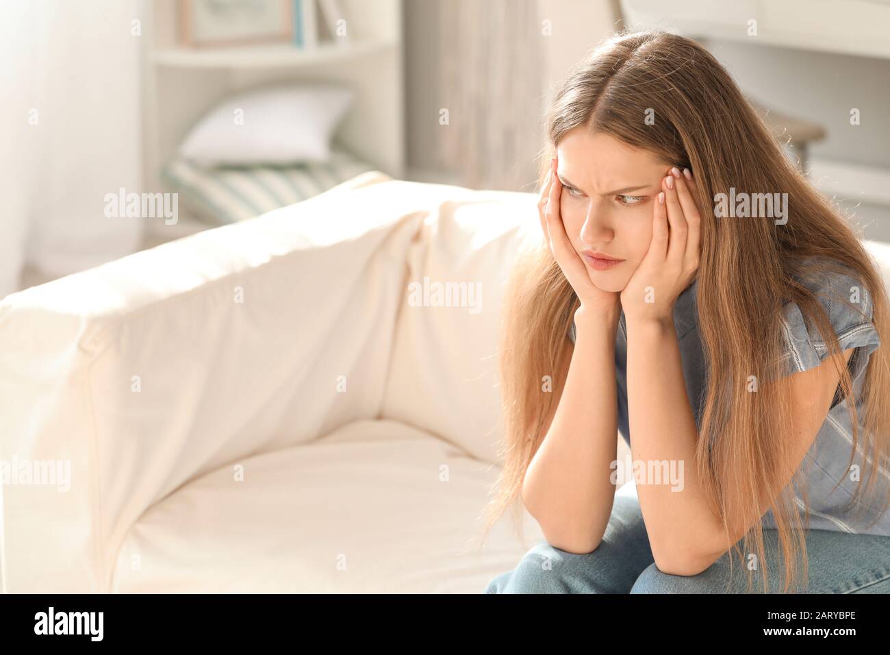 Angry young woman at home Stock Photo - Alamy