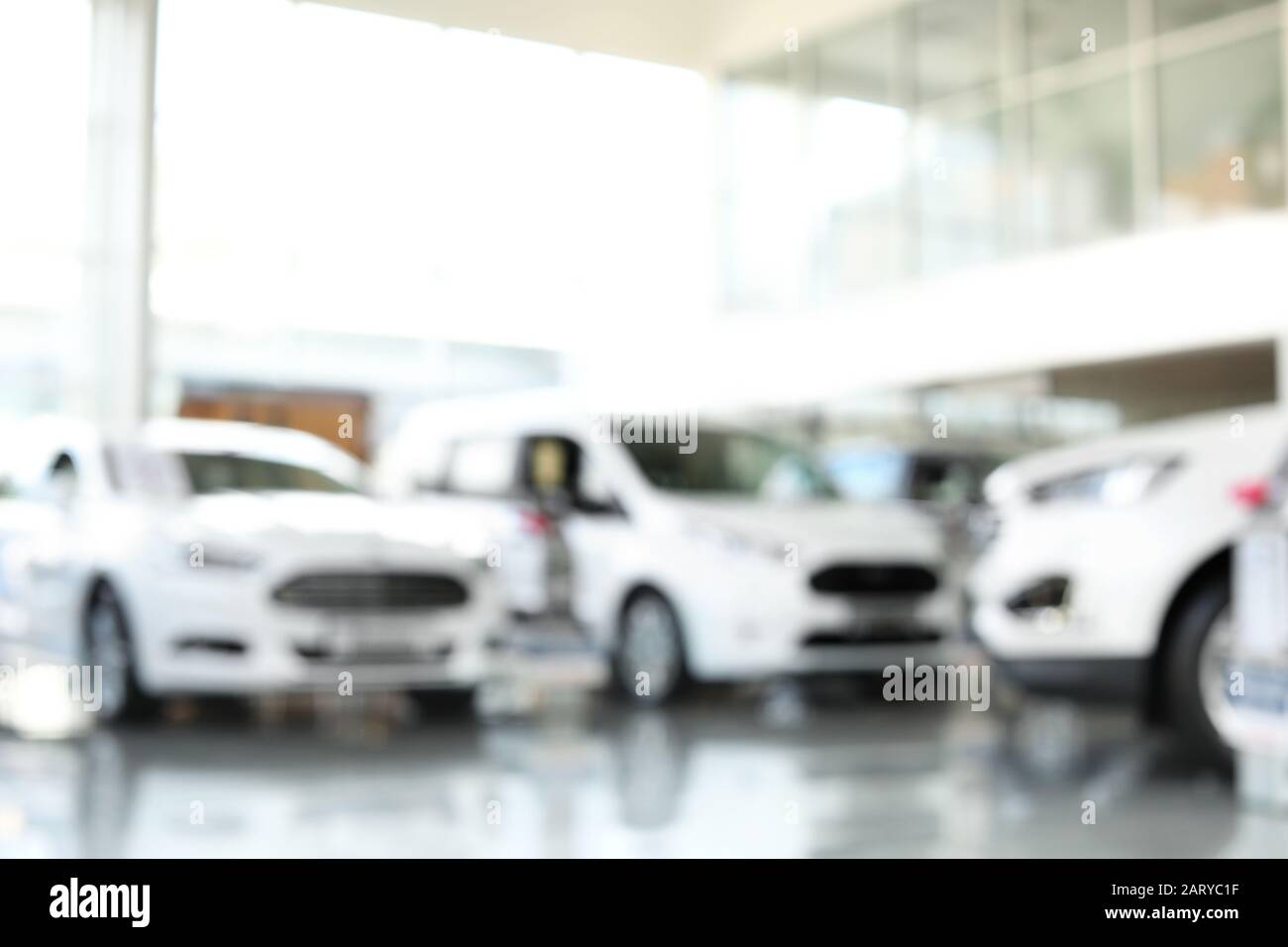 Interior of modern salon with new cars, blurred view Stock Photo - Alamy