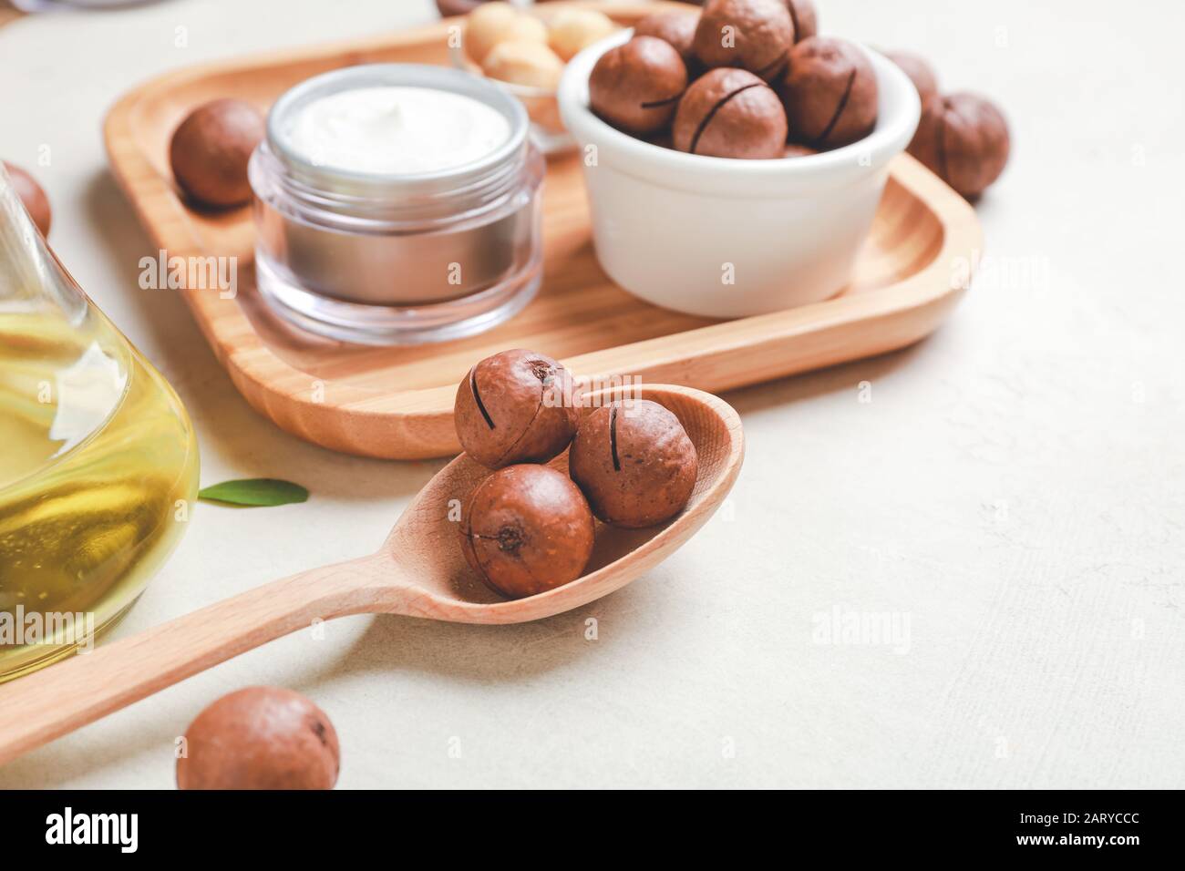 Macadamia nuts with oil and cosmetic cream on white background Stock ...